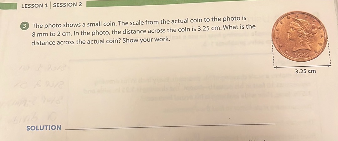The photo shows a small coin. The scale from