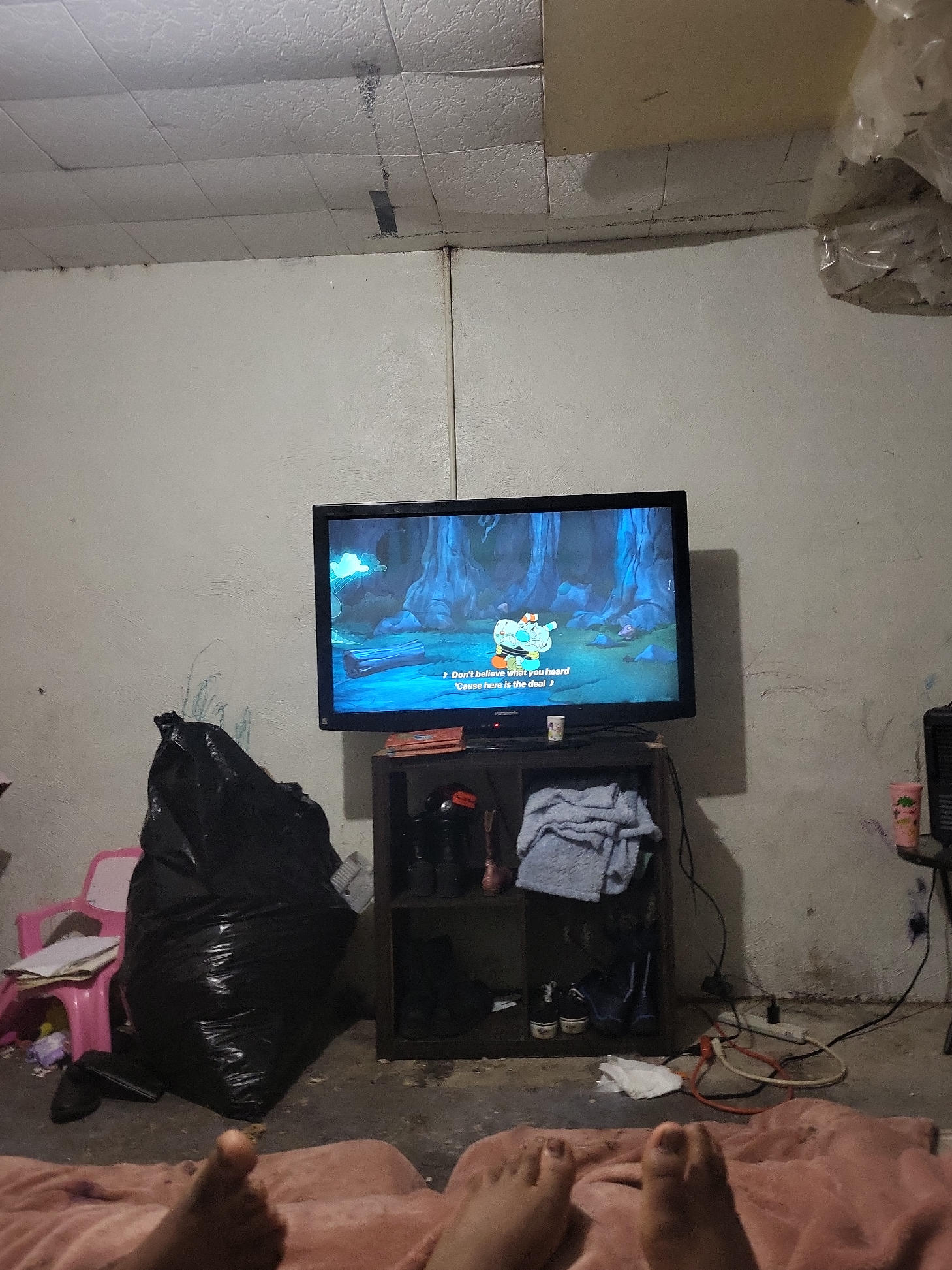 What is the text shown on the TV screen in | StudyX