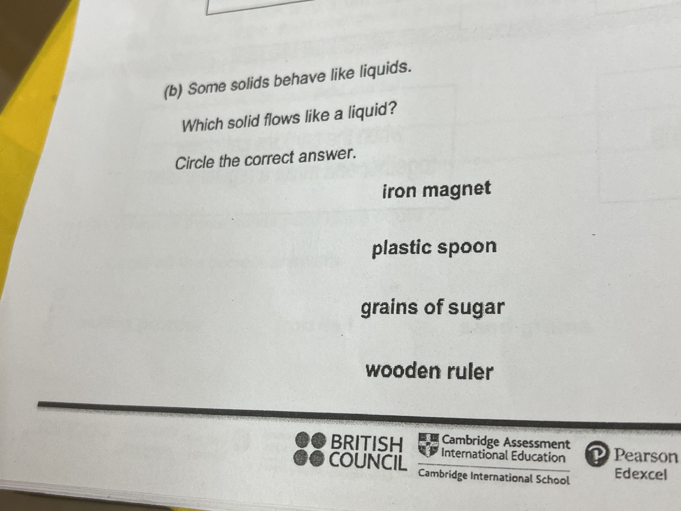 (b) Some solids behave like liquids. Which