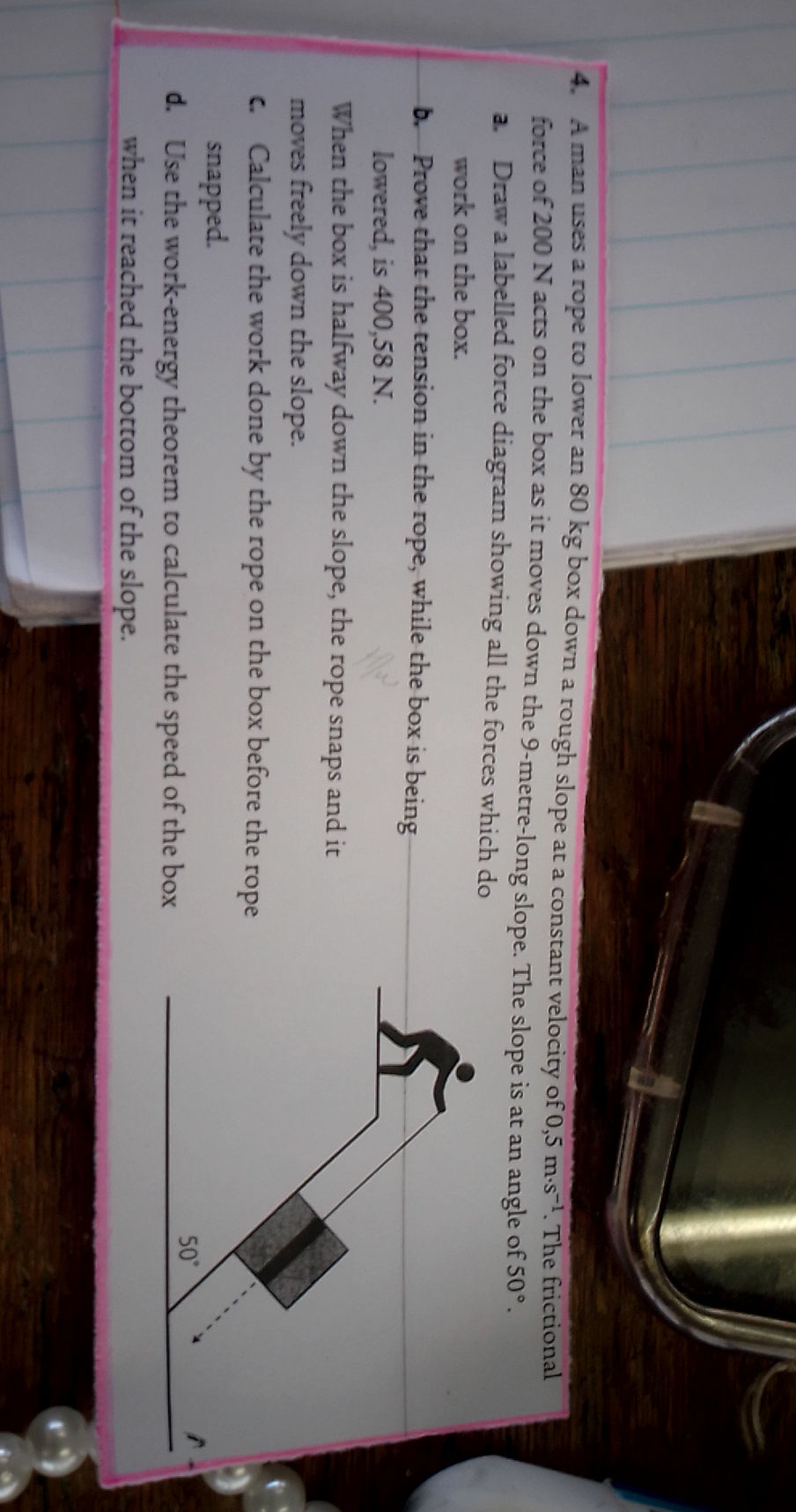 4. A man uses a rope to lower an 80 kg box | StudyX