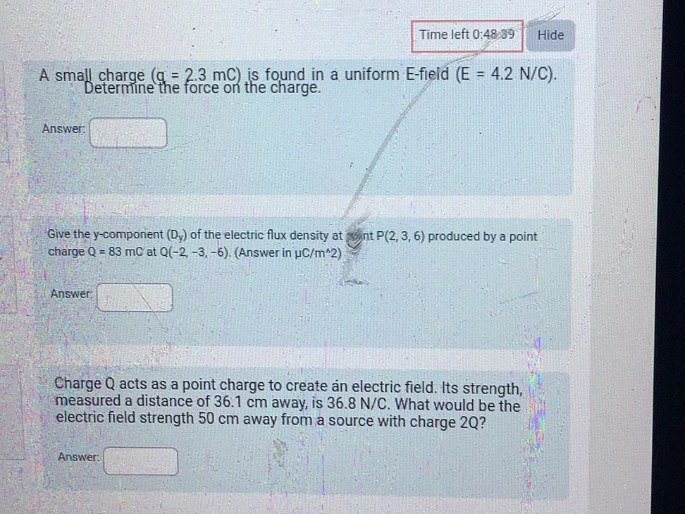 A small charge (q = 2.3 mC) is found in a | StudyX