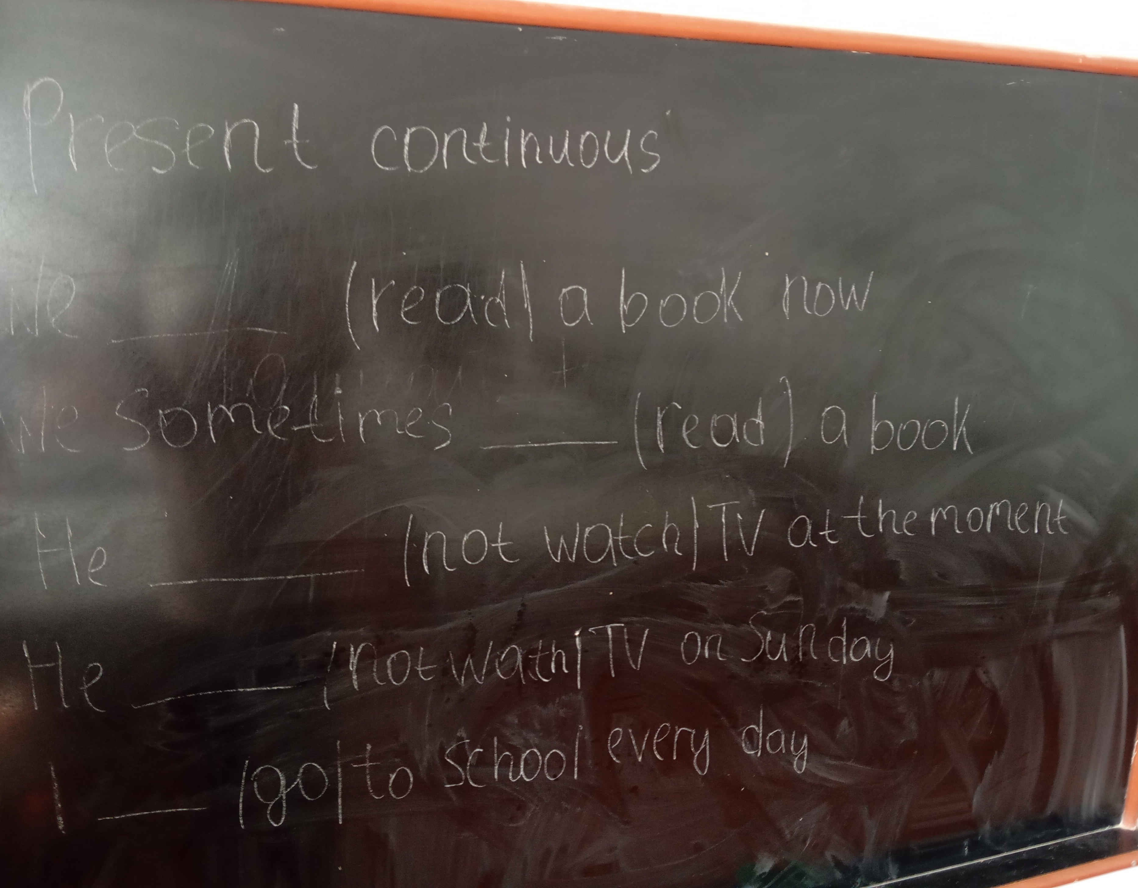 Present continuous He ____ (read) a book now | StudyX