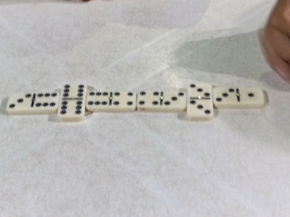 The image shows a sequence of dominoes. The | StudyX
